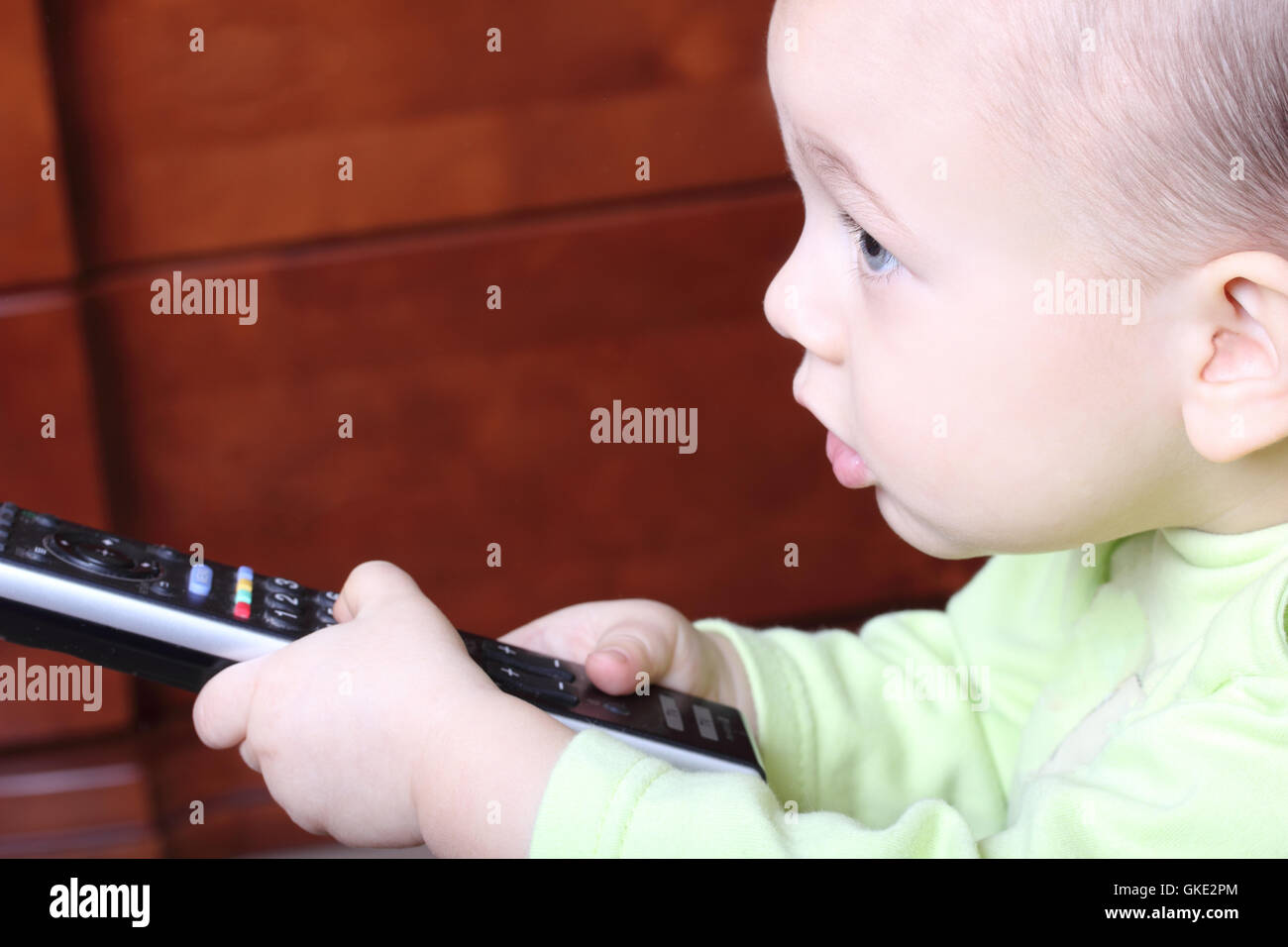 little child with a TV remote control Stock Photo - Alamy