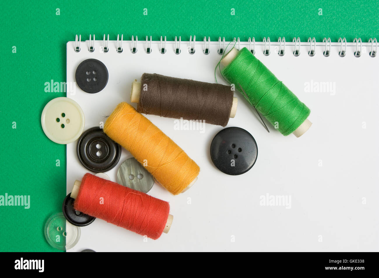 thread with a needle and buttons Stock Photo - Alamy