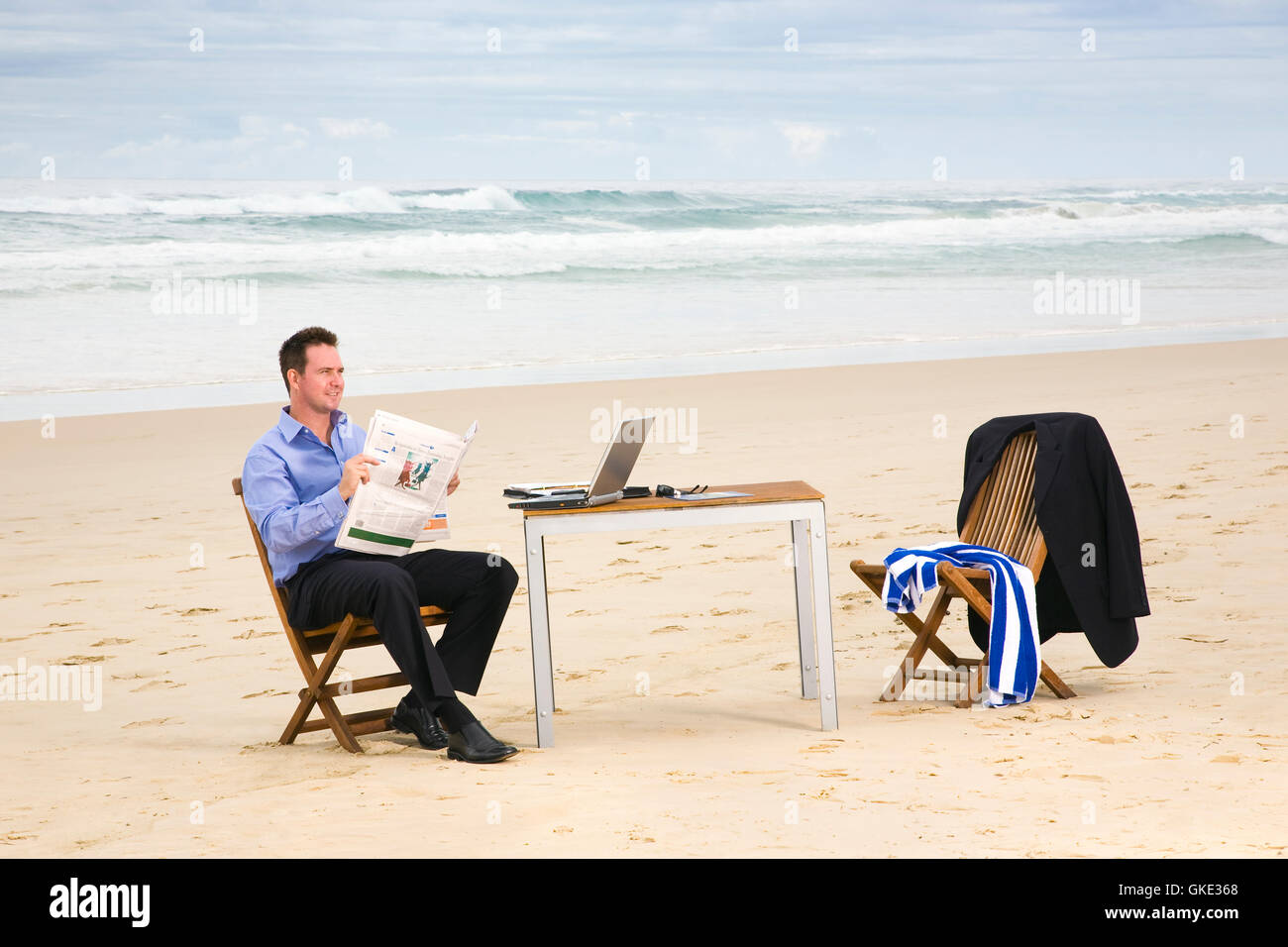 Business man with office on the beach Stock Photo - Alamy