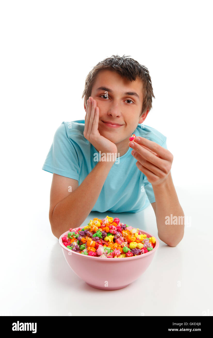 Boy relaxing with bowl popcorn Stock Photo - Alamy