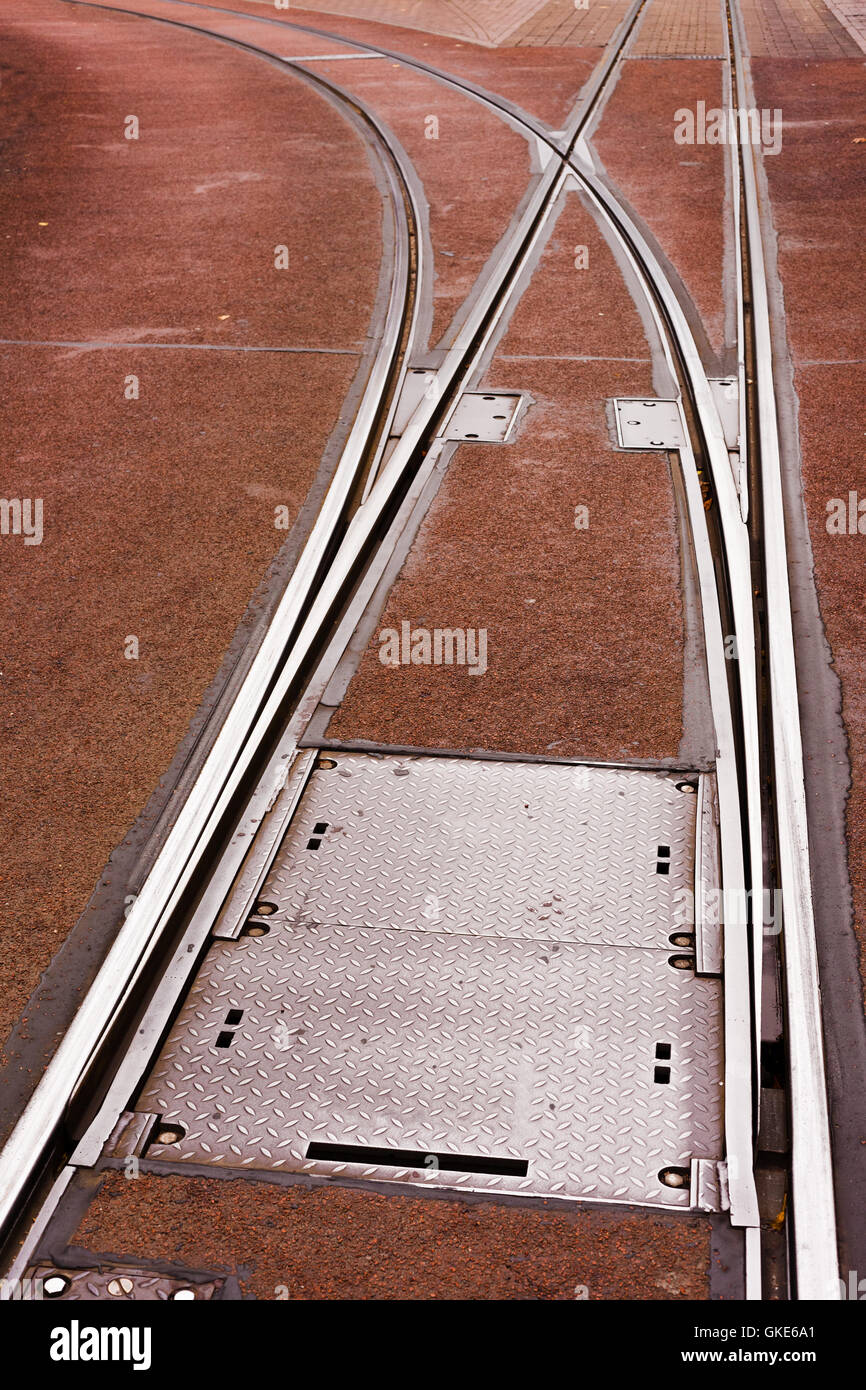 Tram rails and switch in pavement of city street Stock Photo - Alamy