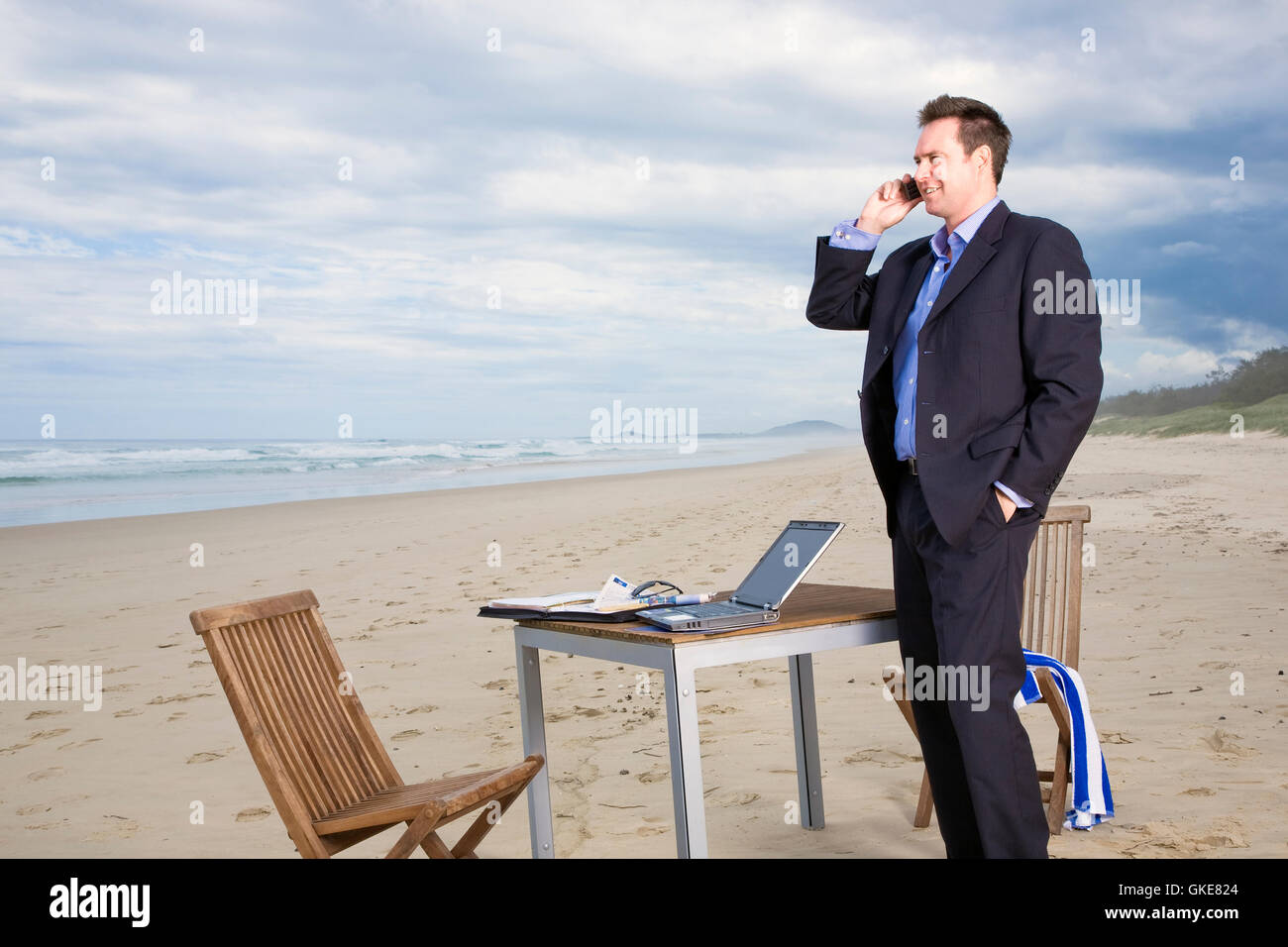 Business man with office on the beach Stock Photo - Alamy