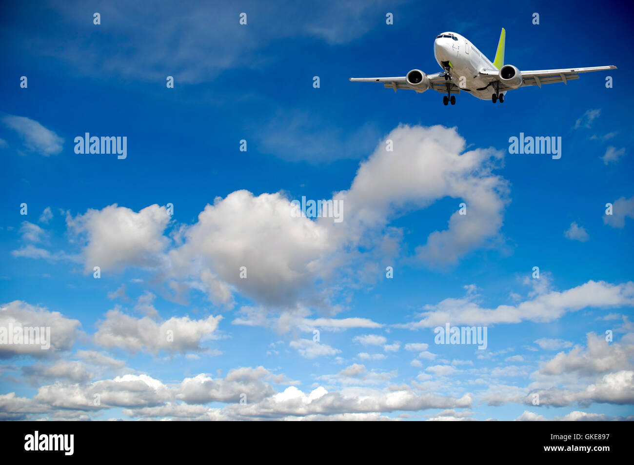 Air travel - Plane flying in blue sky with clouds Stock Photo - Alamy