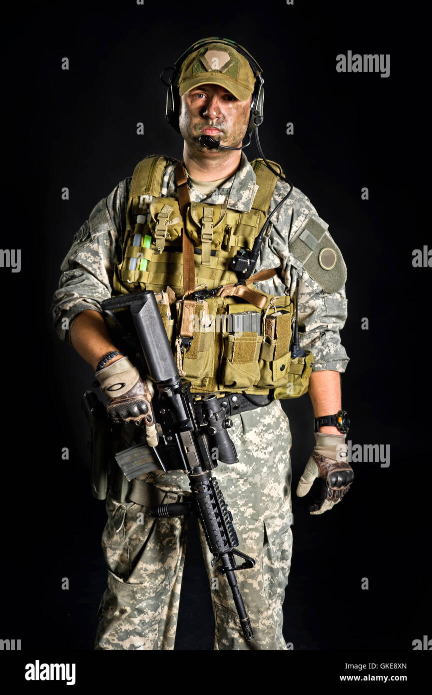 Soldier posing with a gun Stock Photo - Alamy