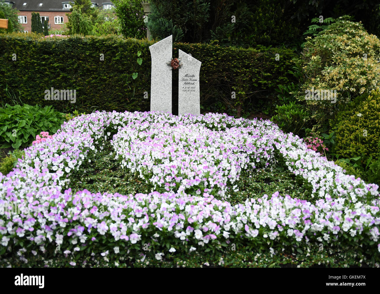 A new gravestone is placed on the grave of Luisa Feldbusch, mother of ...