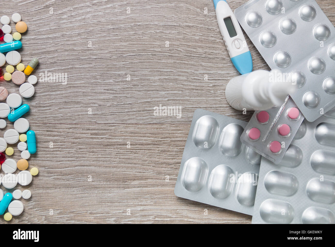 A lot of colorful medication and pills from above on grey wooden ...