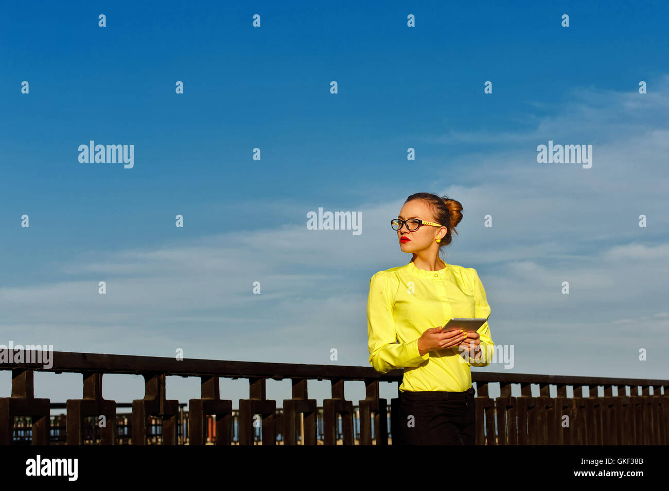 Girl waiting for a letter by e-mail outdoors. Business woman at work ...