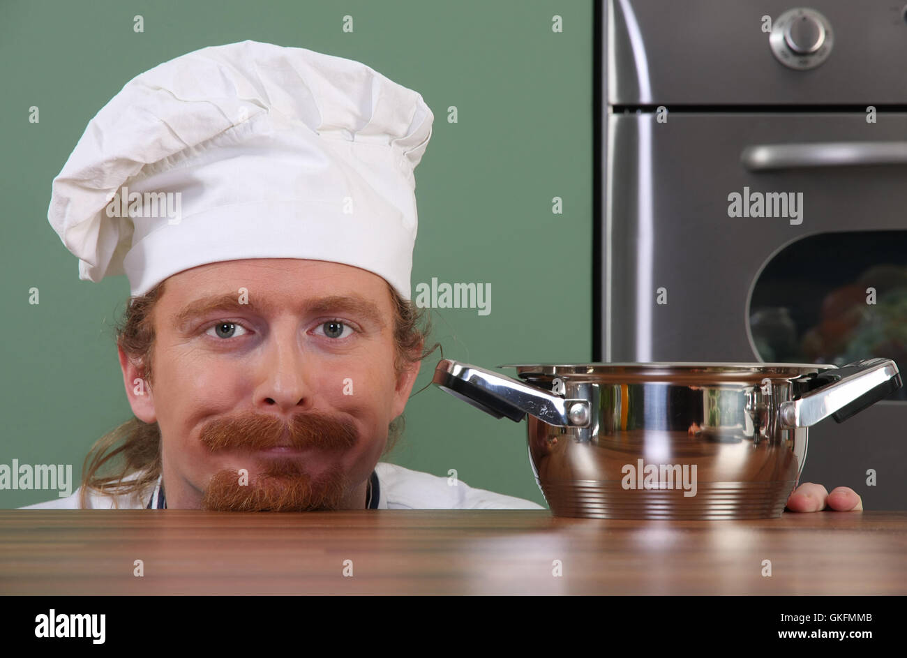 Funny young chef with a pot Stock Photo - Alamy