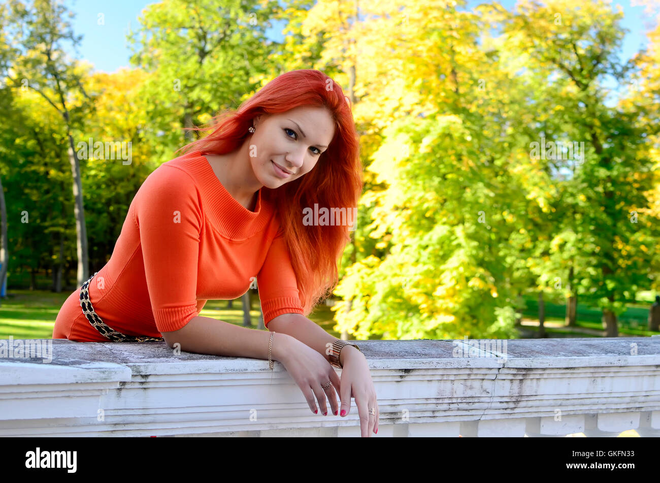 Redhead girl standing at the railing Stock Photo - Alamy