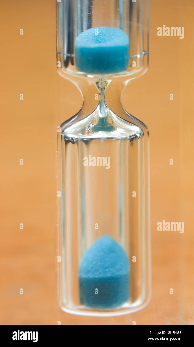 hourglass with blue sand Stock Photo - Alamy