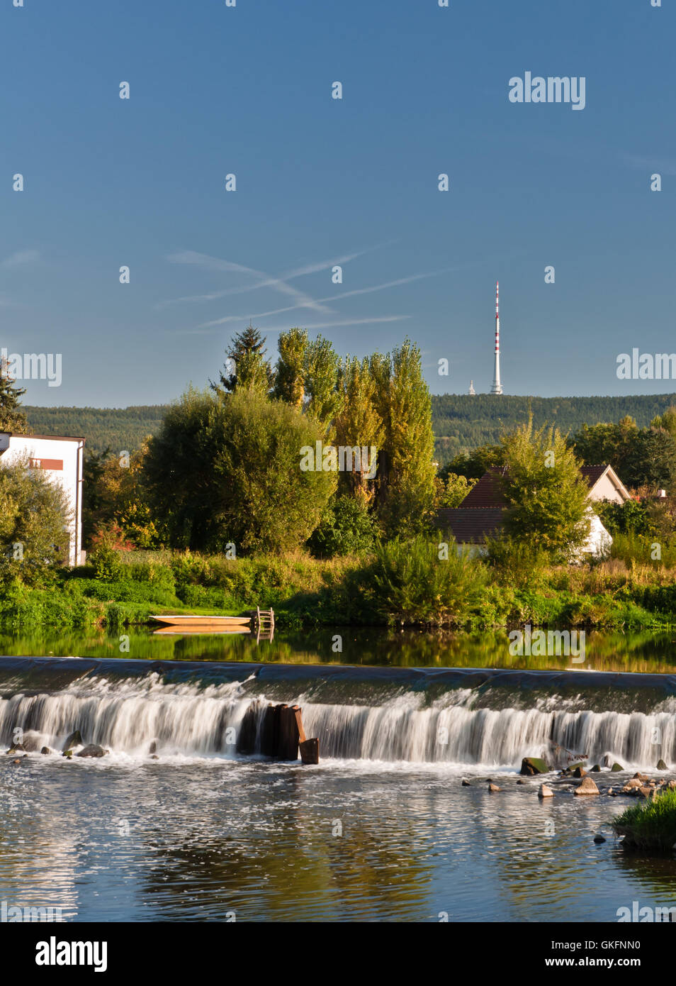 River rapids with boat and houses on background Stock Photo - Alamy