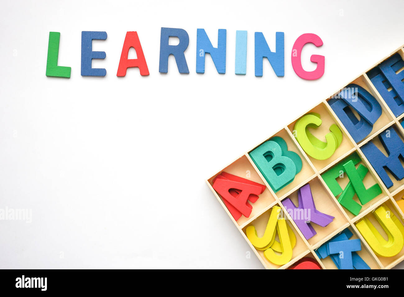 Colorful wooden letter with white background Stock Photo - Alamy