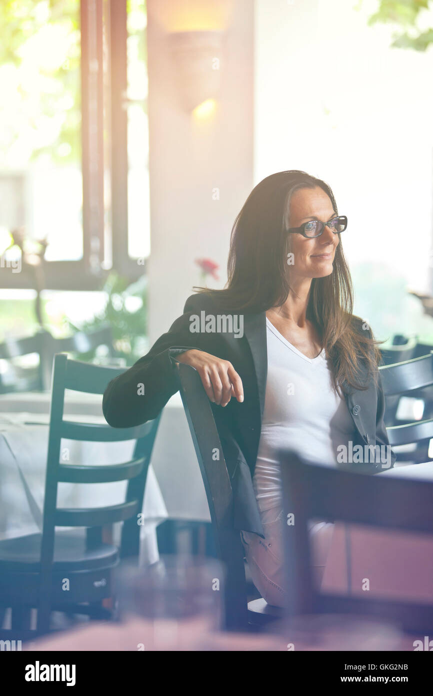 Woman sitting in café hi-res stock photography and images - Alamy