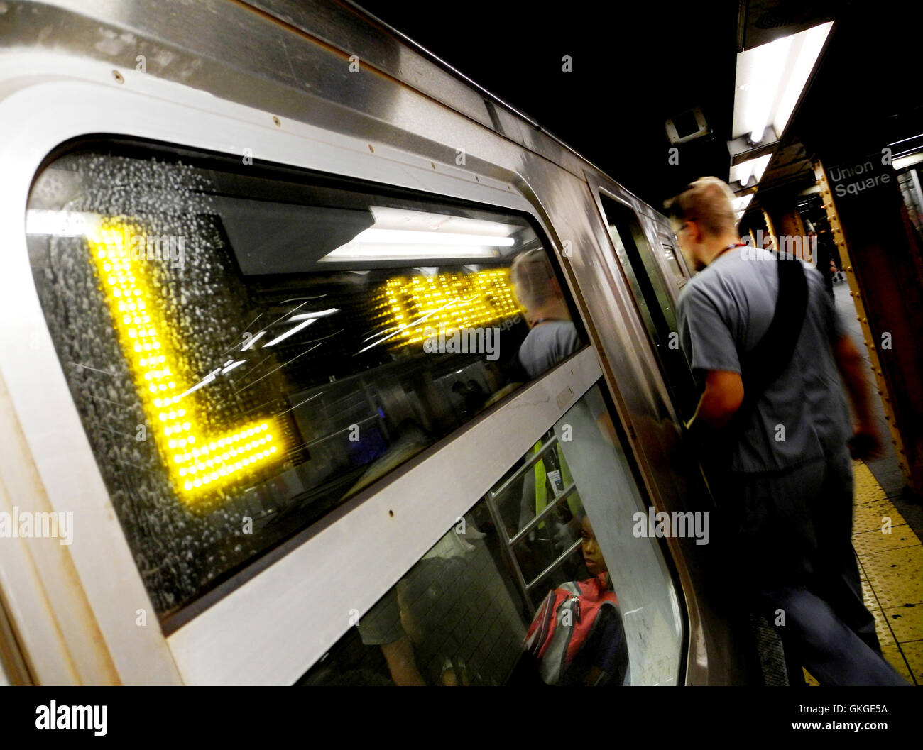 New York, US. 9th Aug, 2016. A man catching a subway train of the L ...