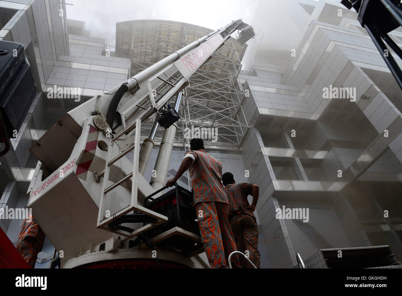 Bangladeshi firefighters work to douse a fire at the Bashundhara City ...