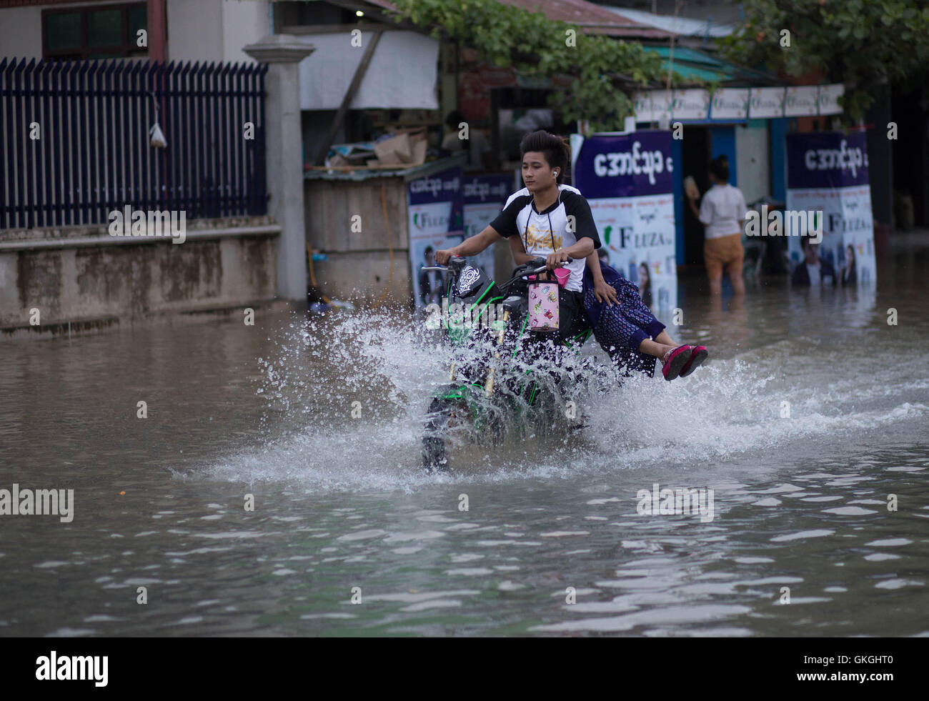Mandalay, Myanmar. 21st Aug, 2016. A resident rides a motorcycle ...