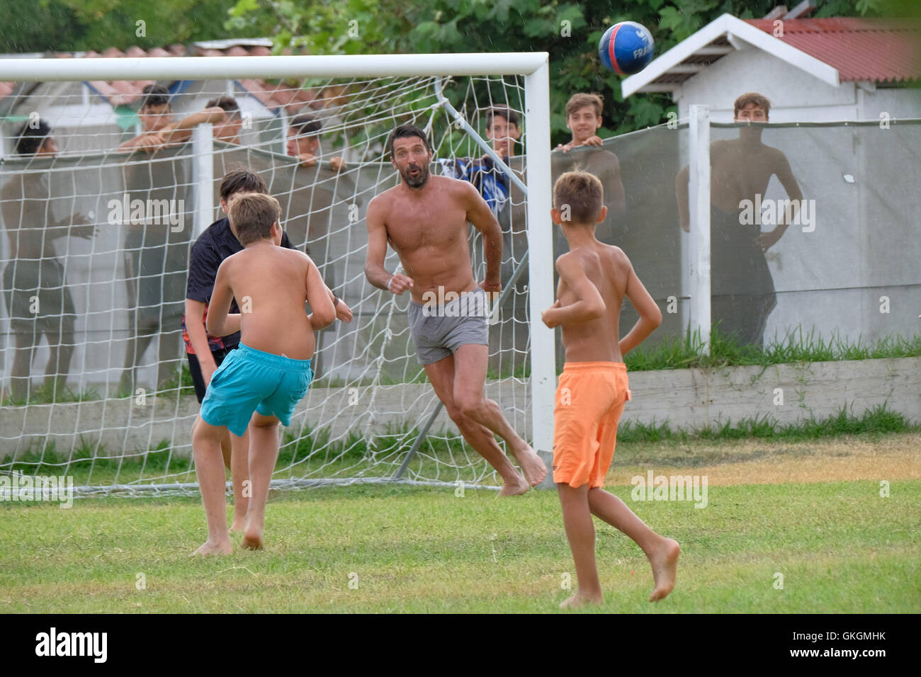 Gigi Buffon plays football in the rain with a group of young children ...