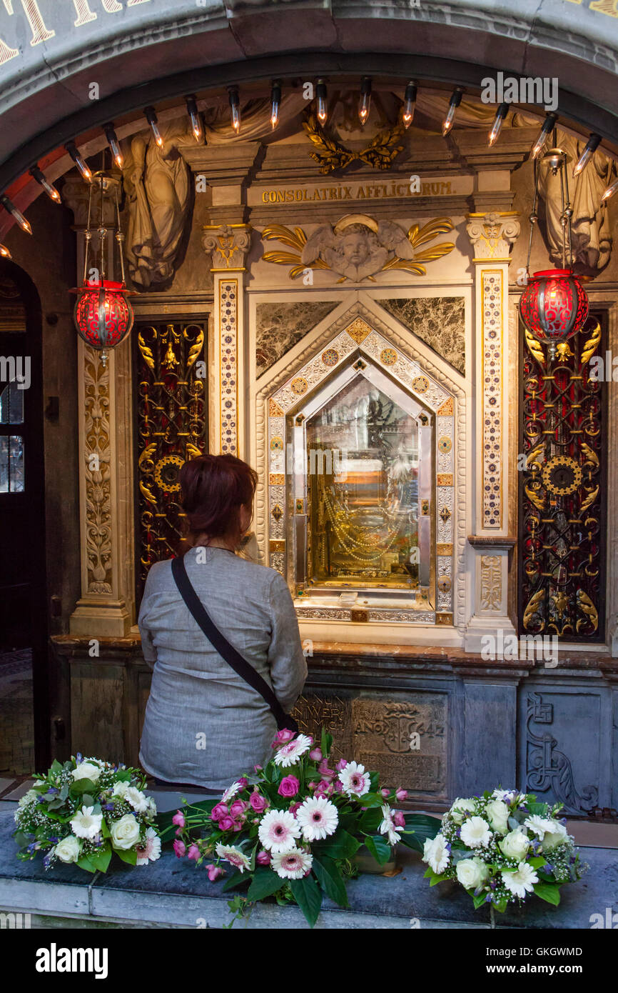 Germany, Kevelaer, woman contemplate the picture of Holy Mary, Full of ...