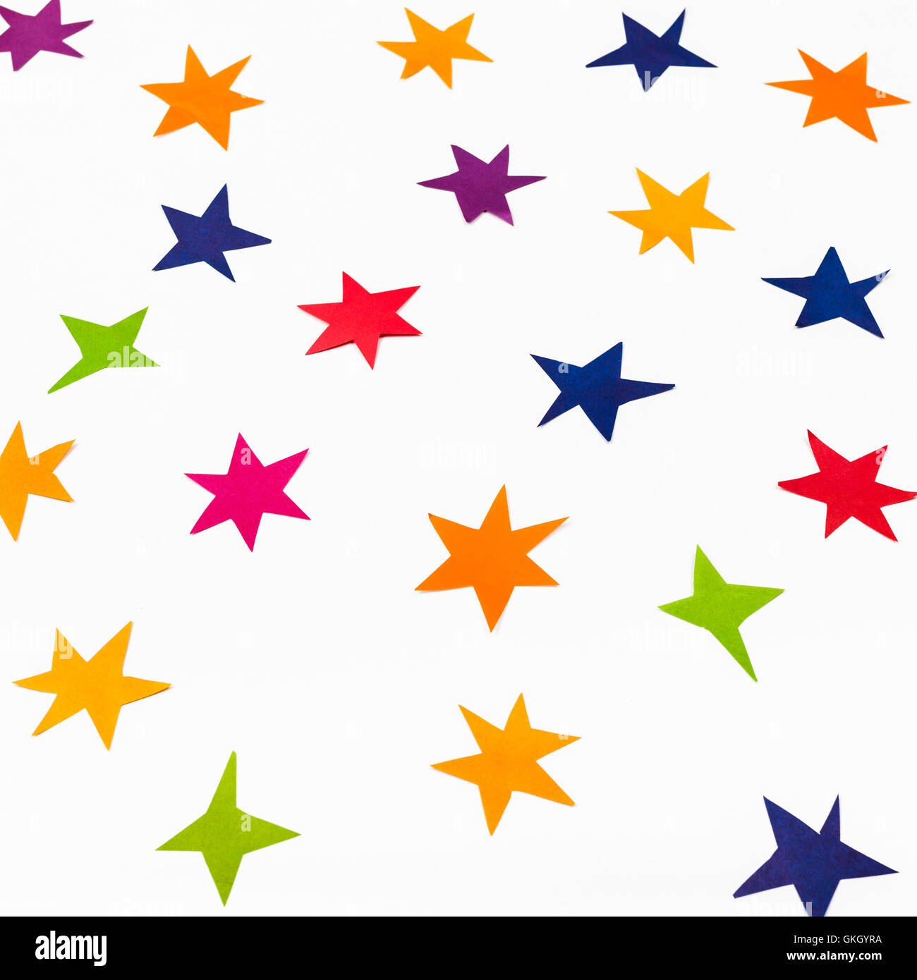 various stars carved from colored paper on white square background ...