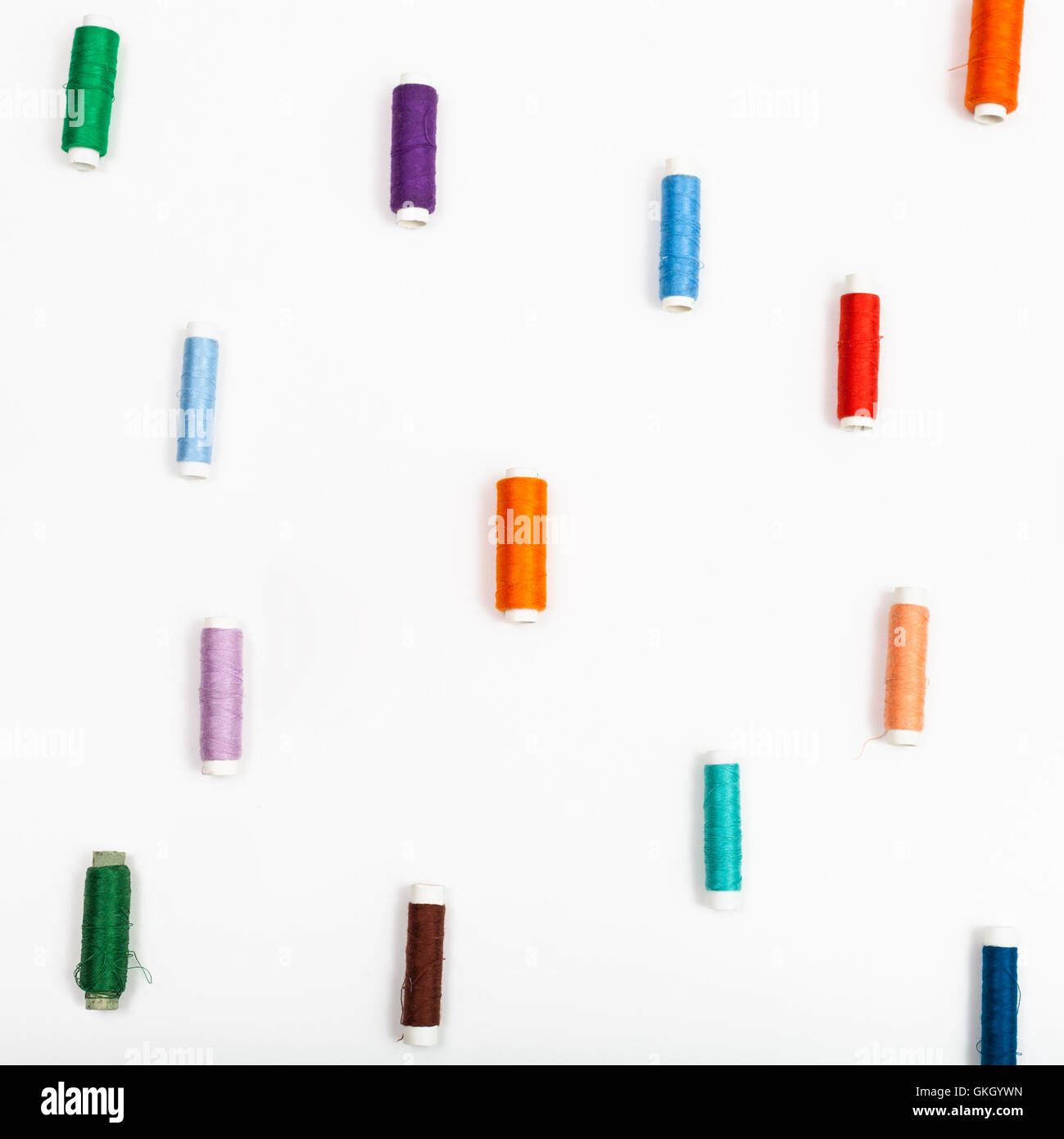 several spools of sewing thread on white background Stock Photo - Alamy