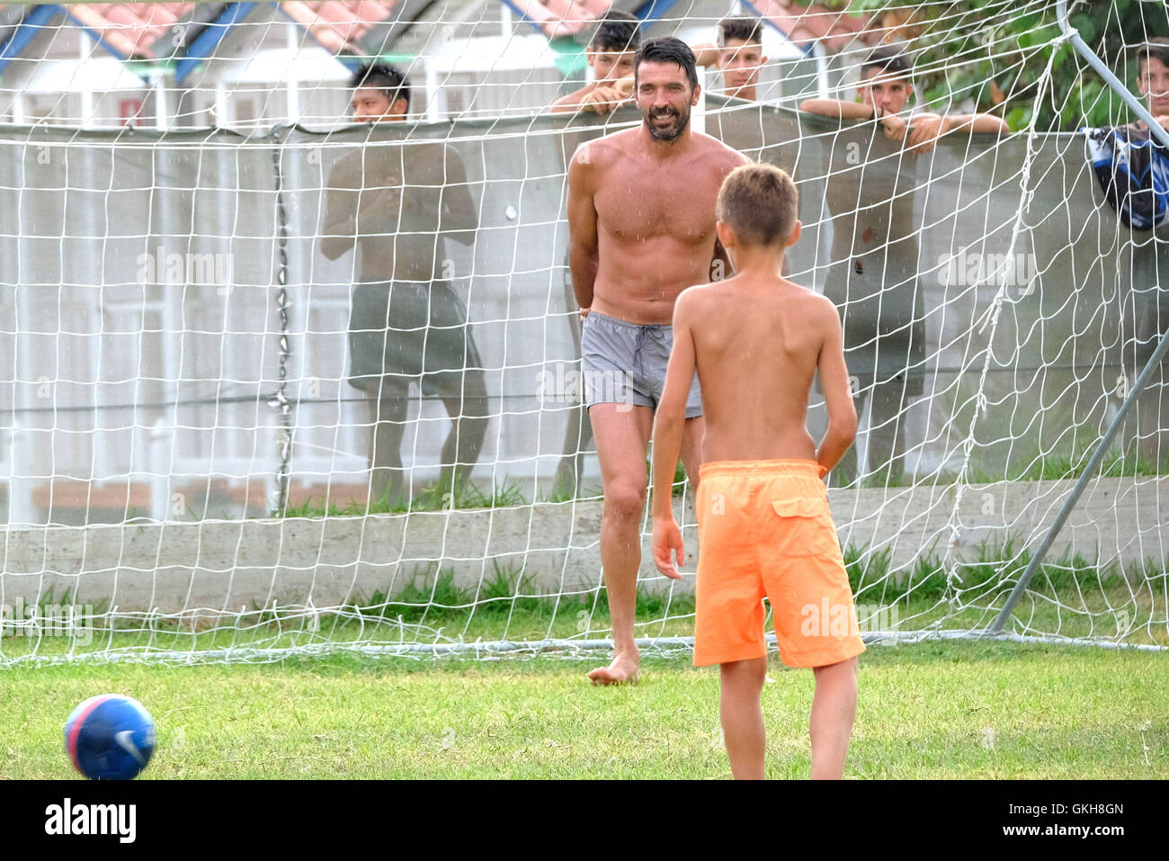 Gigi Buffon plays football in the rain with a group of young children ...