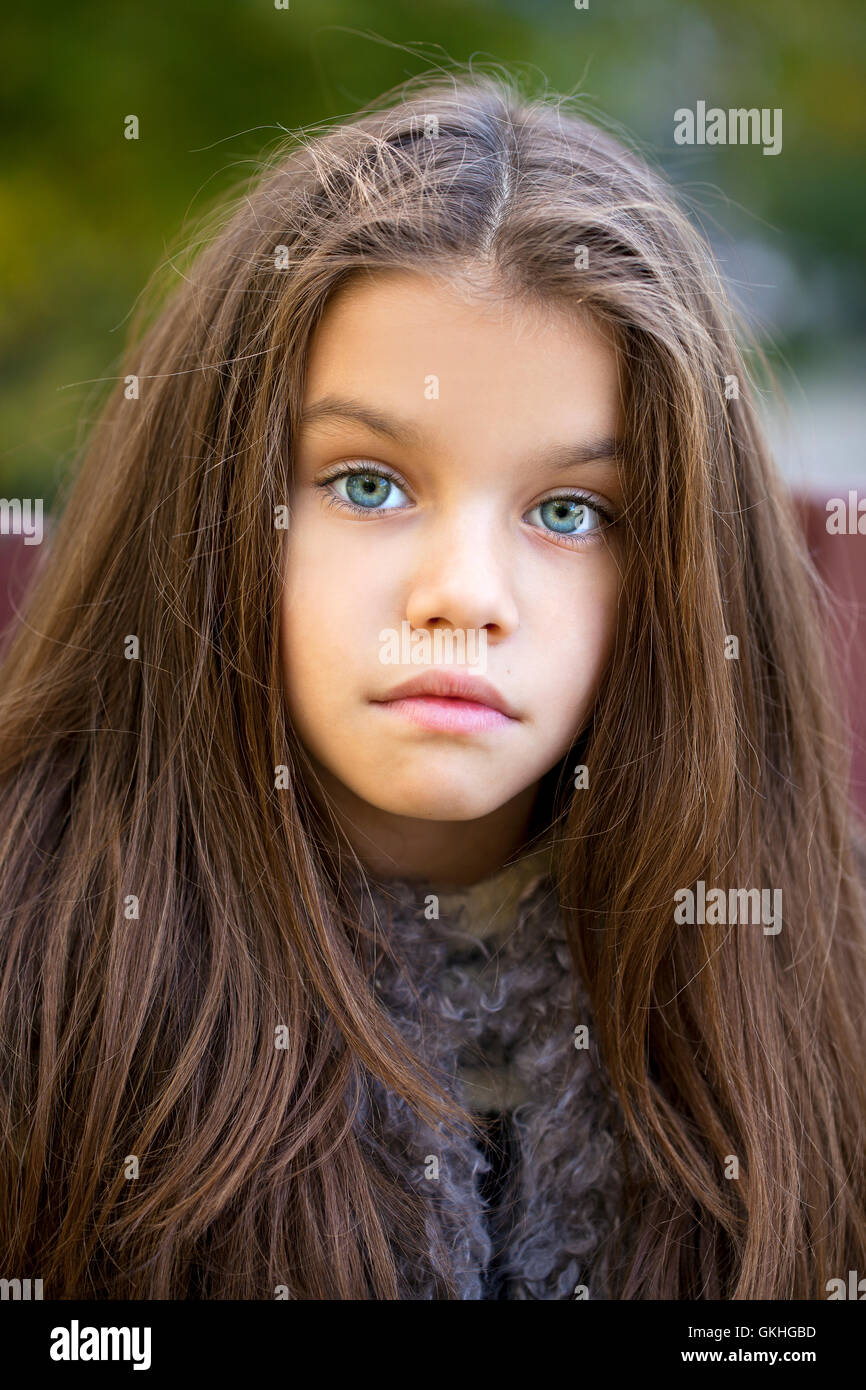 Close up portrait of a beautiful nine year old little girl in autumn ...