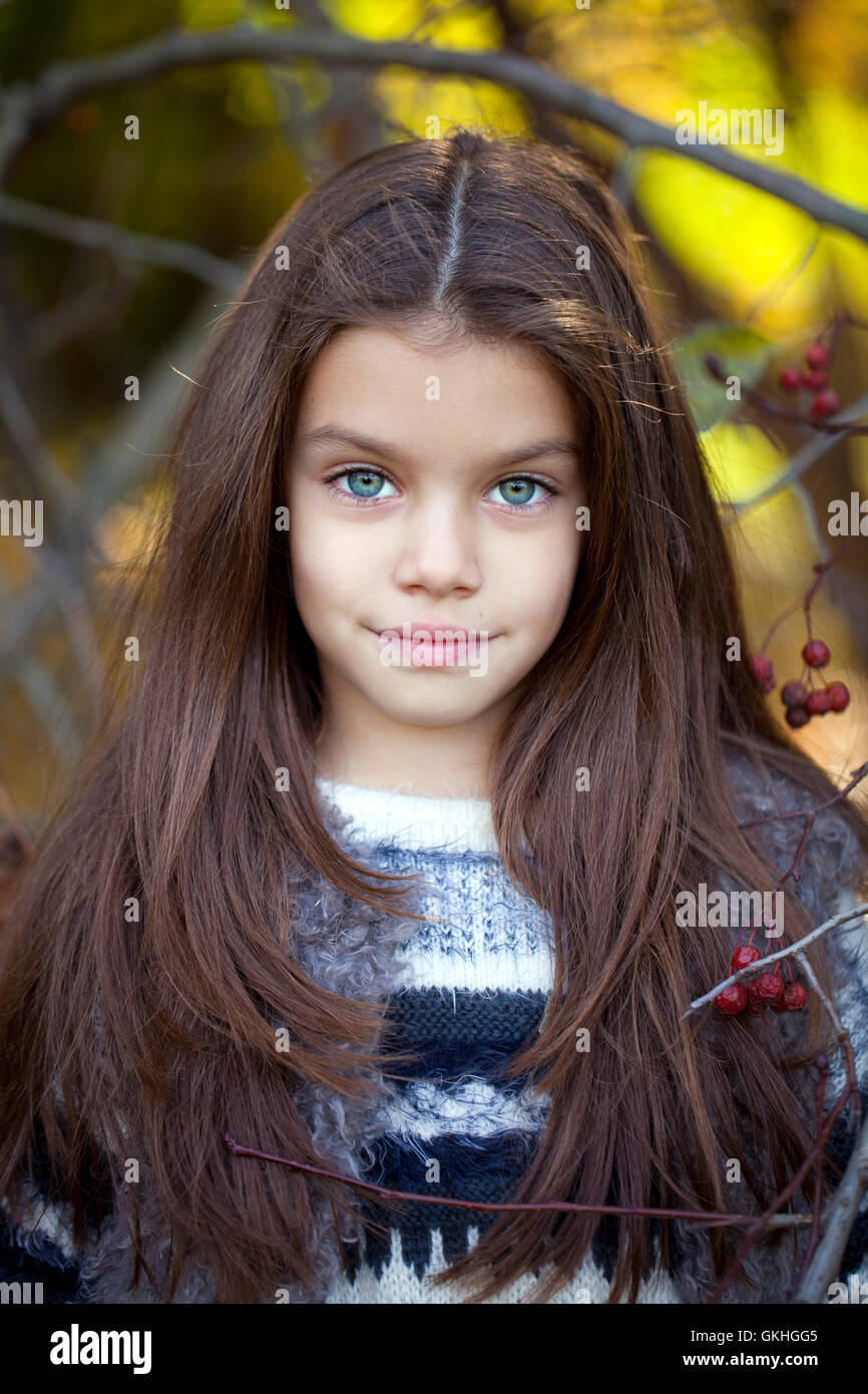 Close up portrait of a beautiful nine year old little girl in autumn ...