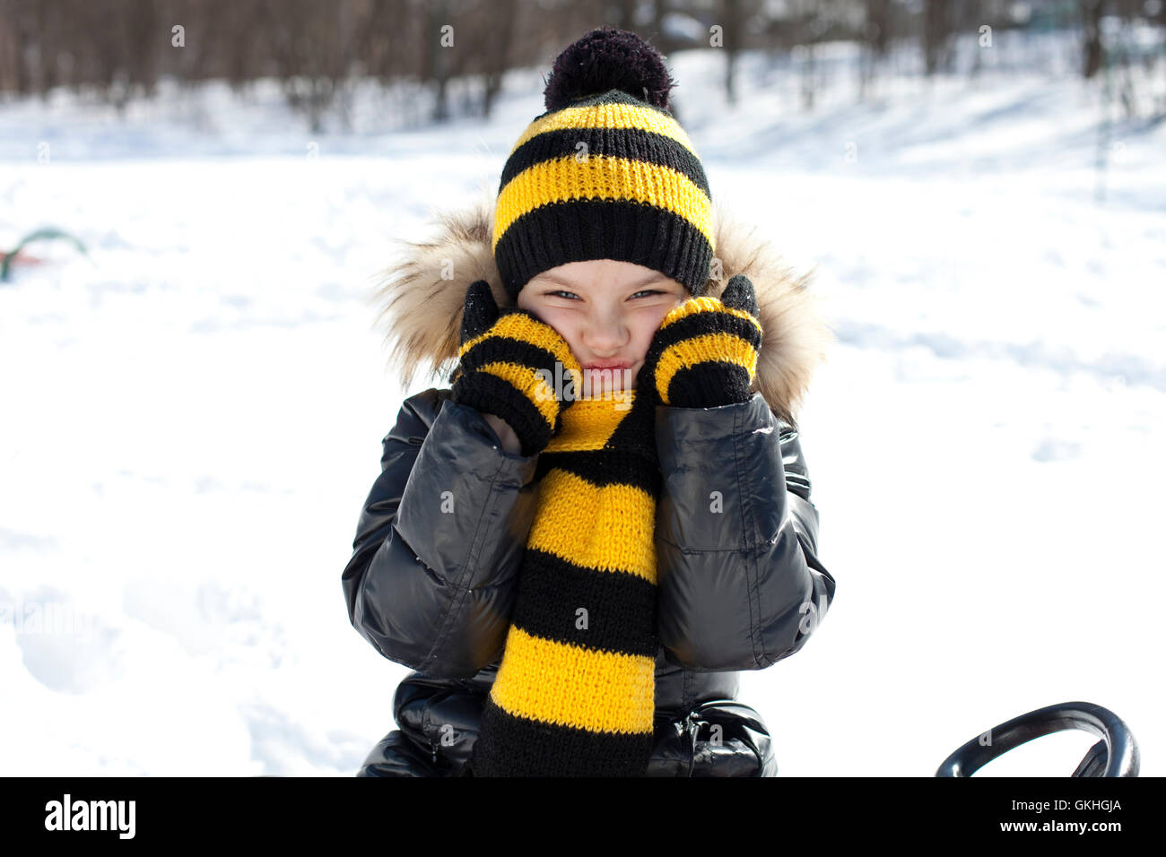 Winter little girl in rest snow park Stock Photo - Alamy