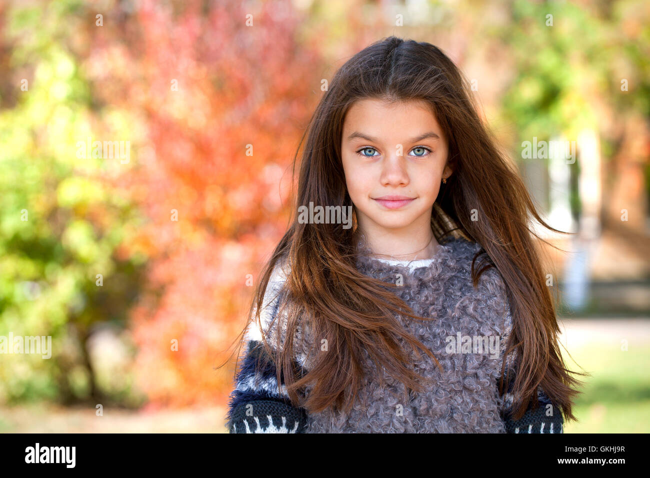 Close up portrait of a beautiful nine year old little girl in autumn ...