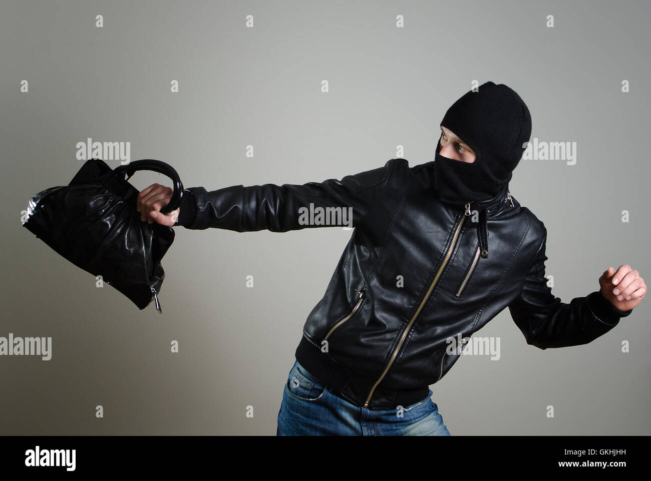Portrait of running male burglar with a handbag Stock Photo - Alamy