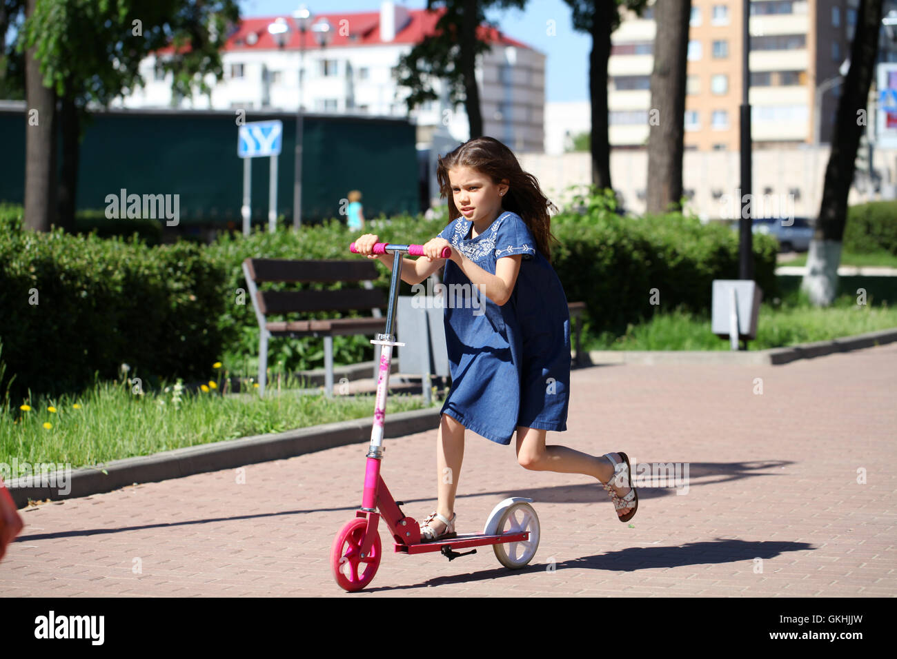 Brunette little girl scooter in hi-res stock photography and images - Alamy