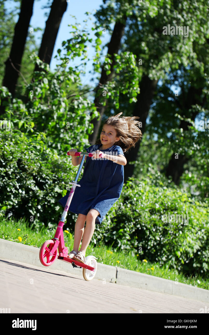 Brunette little girl scooter in hi-res stock photography and images - Alamy