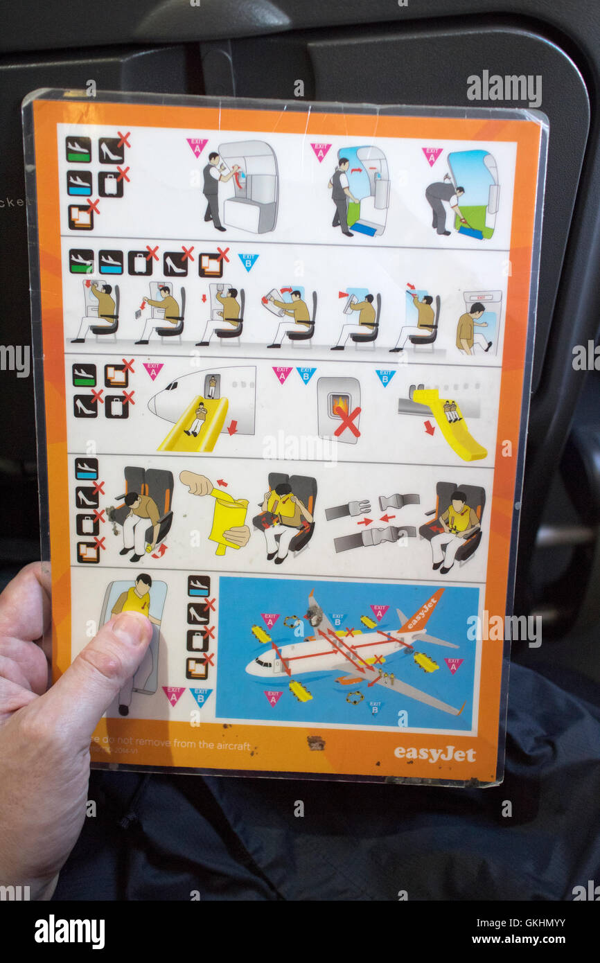 mans hand holding easyjet aircraft air passenger safety leaflet card ...