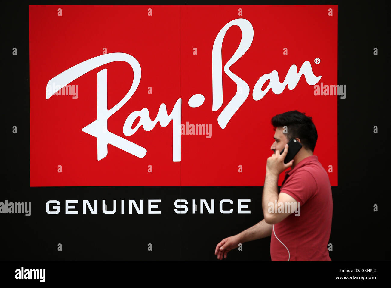 UK, London : A person walks past a Ran Ban logo on Oxford Street in ...