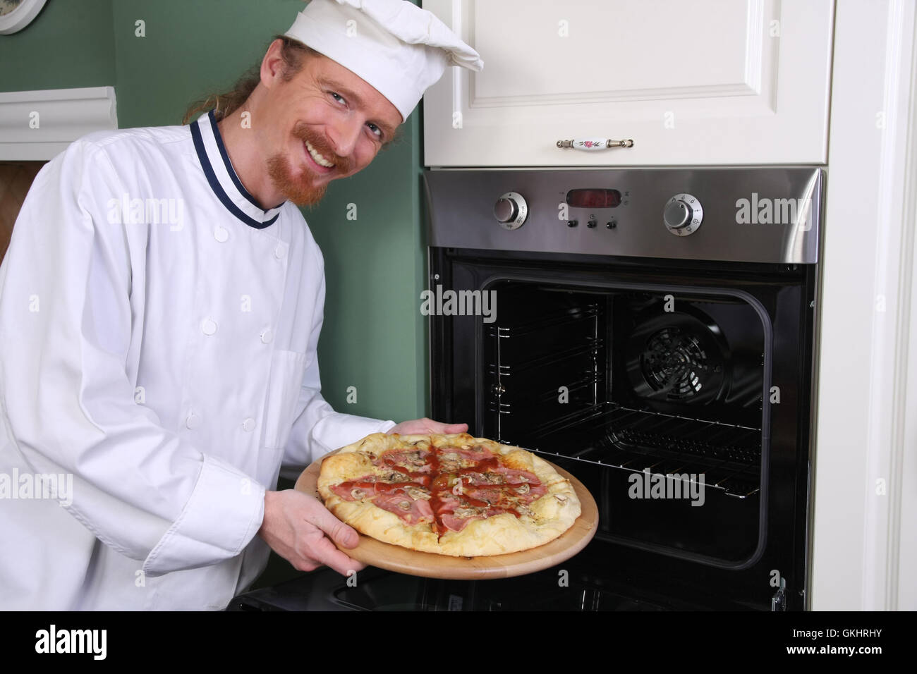 young chef with italian pizza in kitchen Stock Photo - Alamy