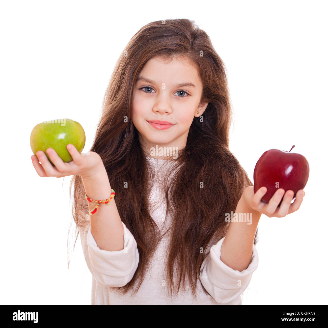 Little girl holding two apples, isolated on white background Stock ...
