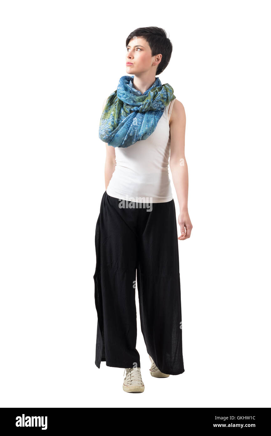 Front view of confident fashion model walking forward looking up. Full ...