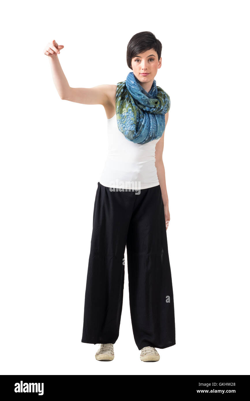 Cute young woman pointing finger at camera in gangster posture. Full ...