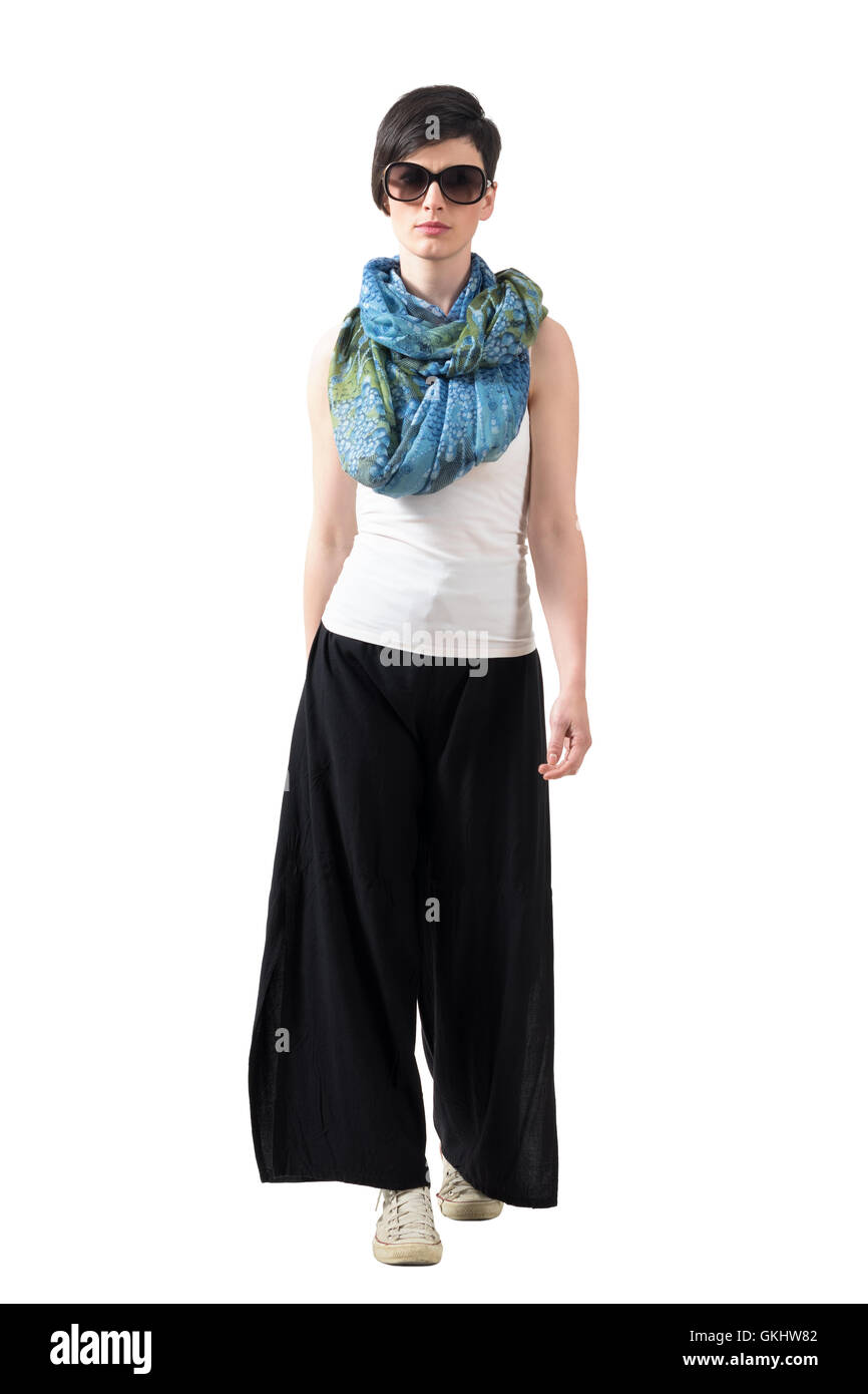 Gorgeous runway fashion model with sunglasses walking and looking at ...