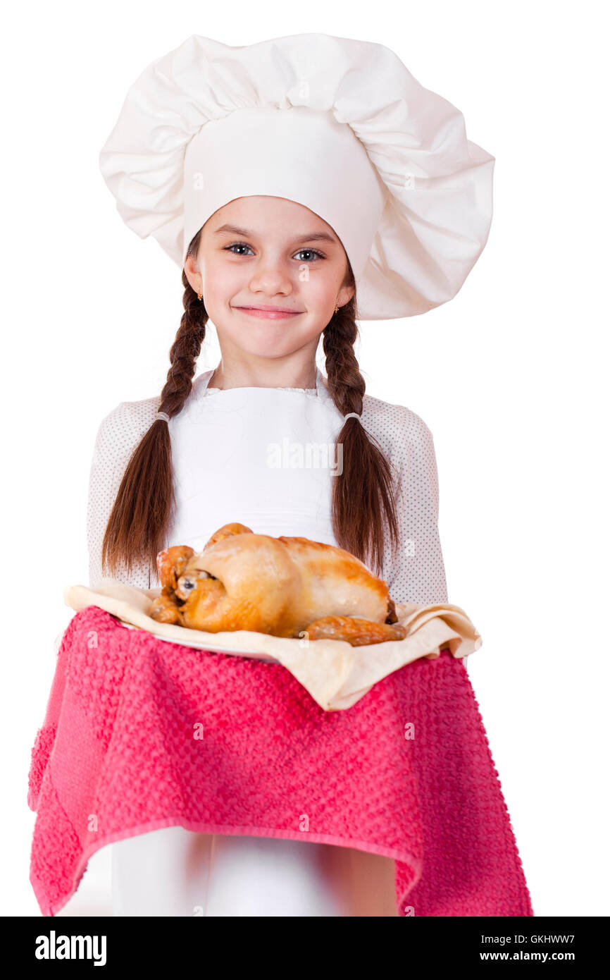 Little girl in a white apron holds on a plate of fried chicken ...