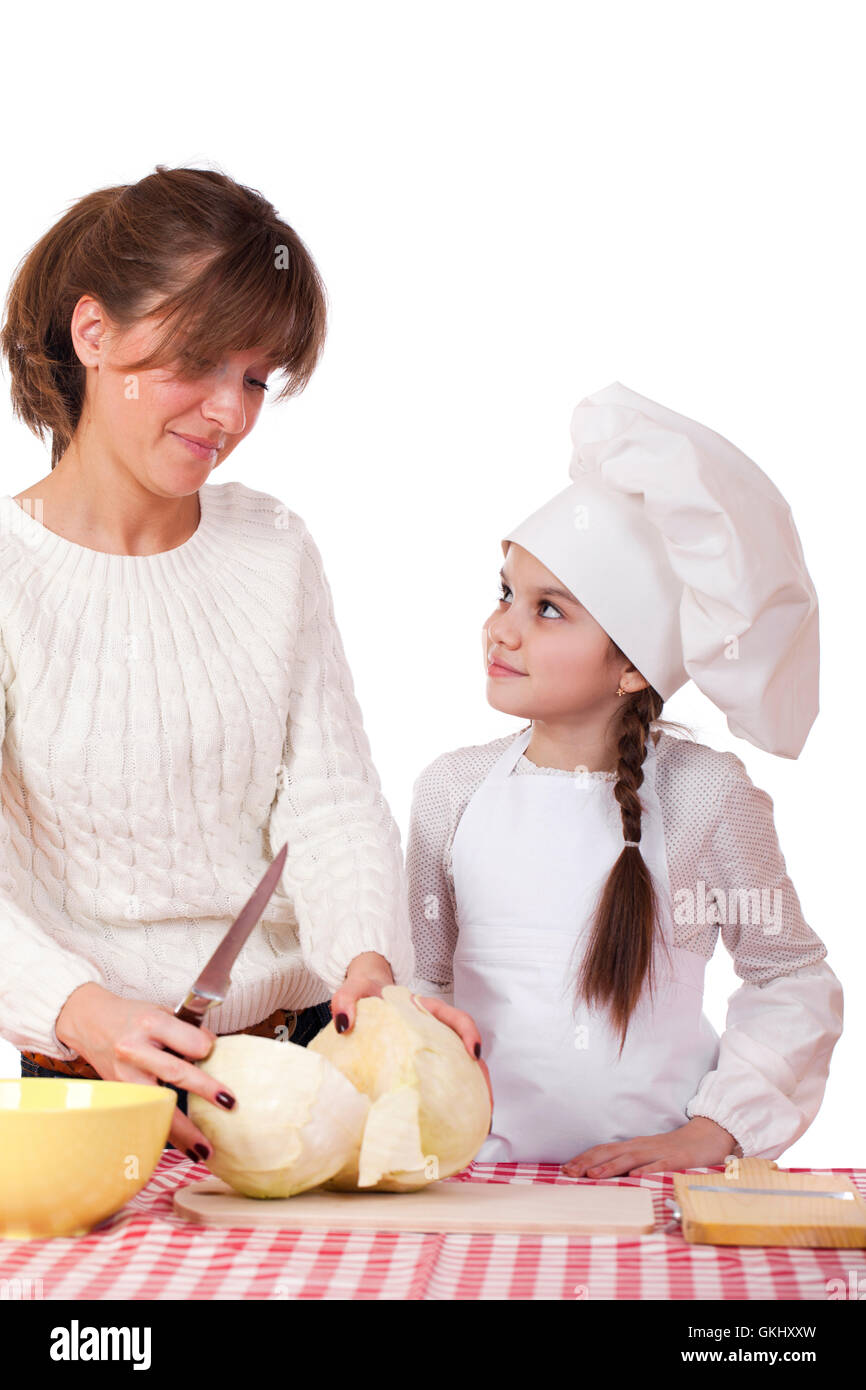 Cooking and people concept - Little girl in cook hat and mother ...