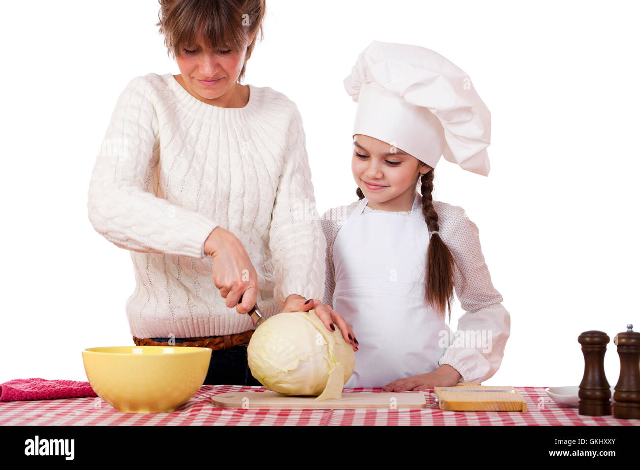 Cooking and people concept - Little girl in cook hat and mother ...
