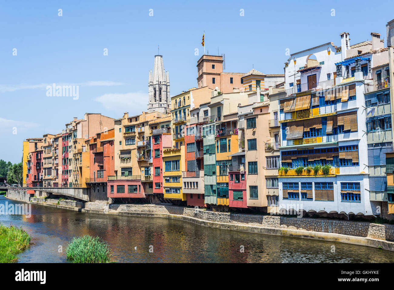 Onyar river crossing the downtown of Girona with bell tower of Basilica ...