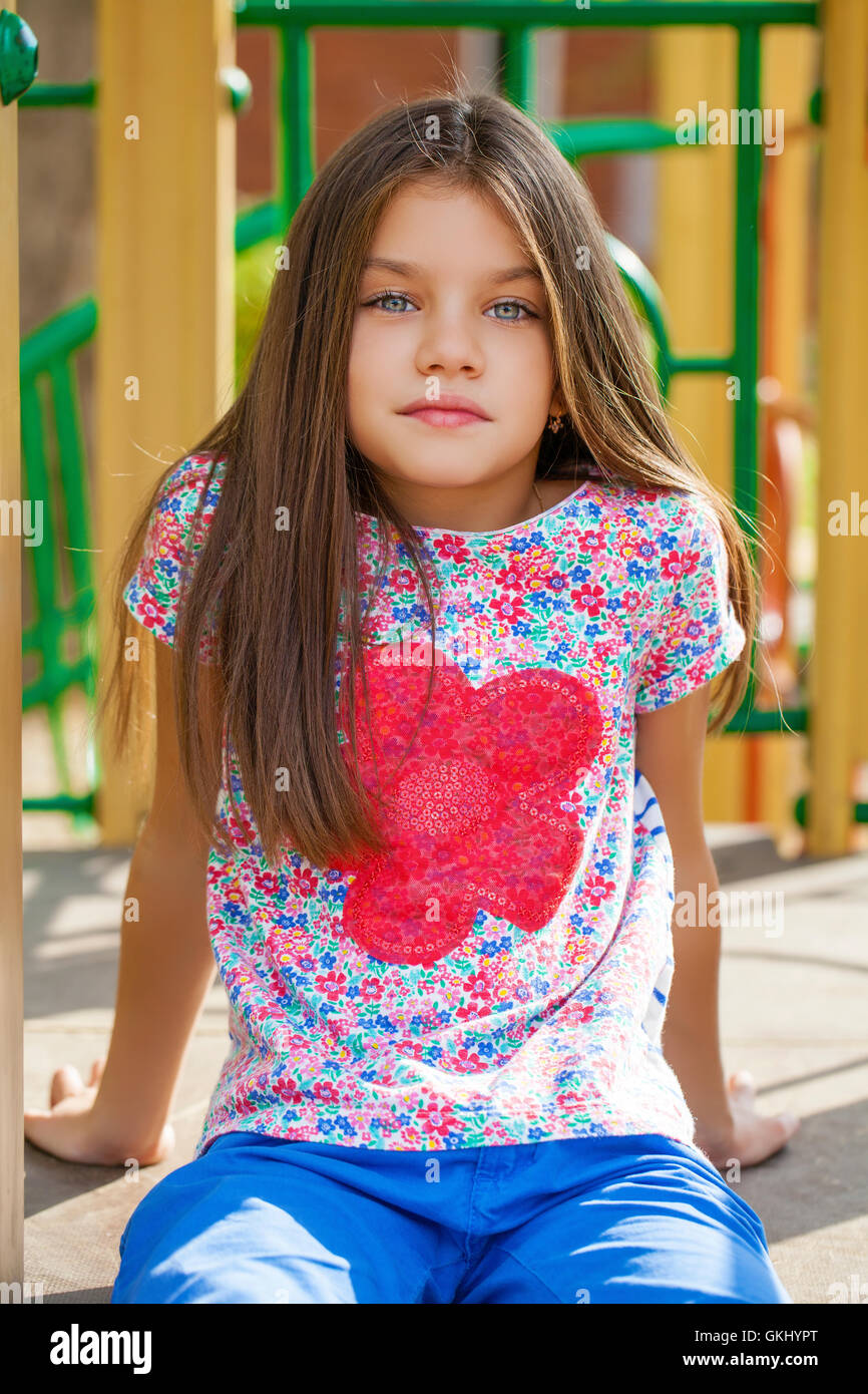 Cose up, Beautiful little girl on green background of summer city park ...