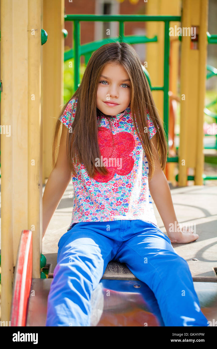 Cose up, Beautiful little girl on green background of summer city park ...