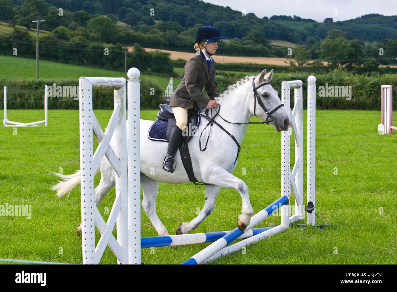 Teenage girl show jumping on her pony at Llanigon YFC Show 2016 nr Hay ...