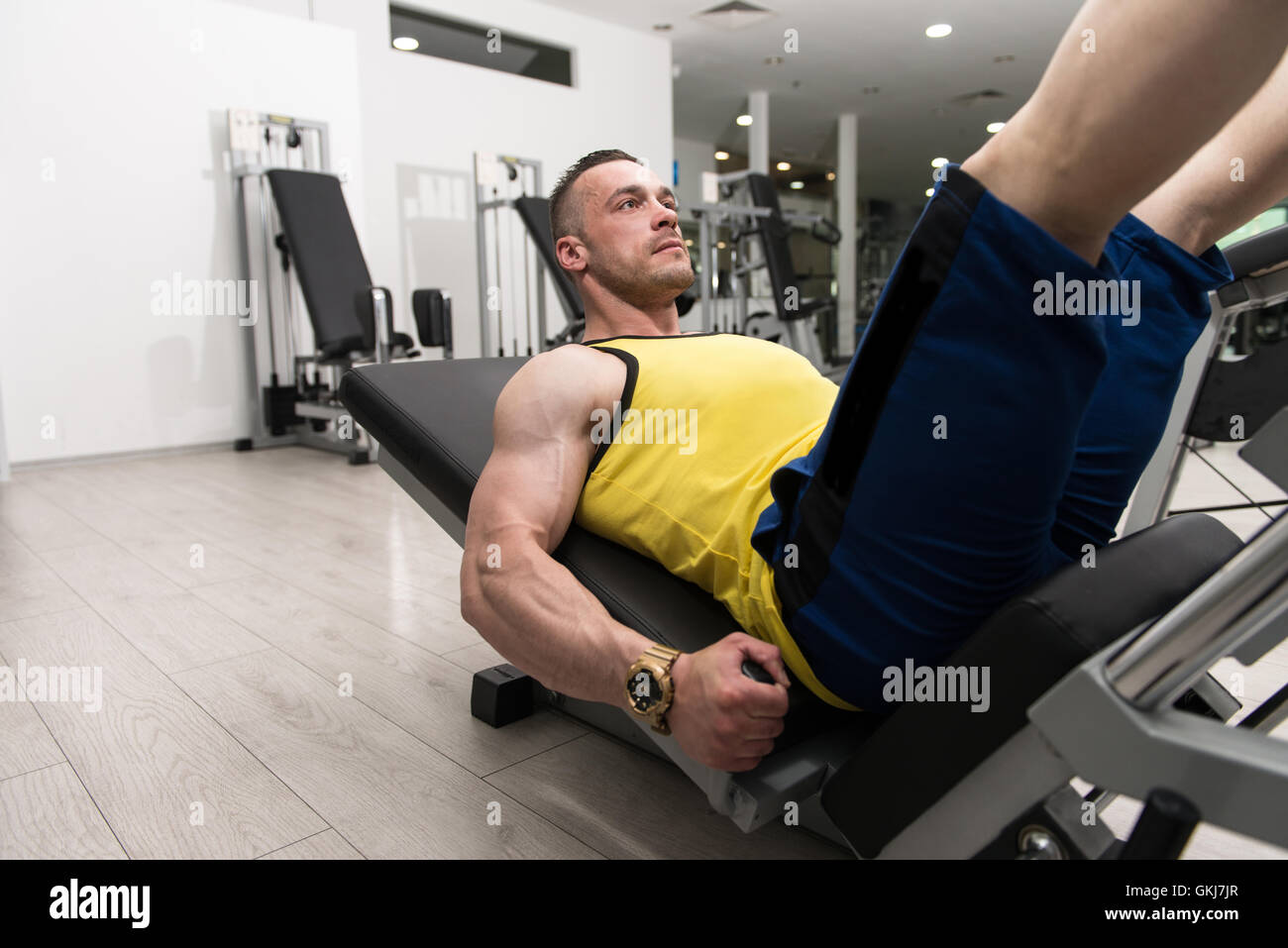 Young Man Using The Leg Press Machine At A Health Club In Gym Stock ...
