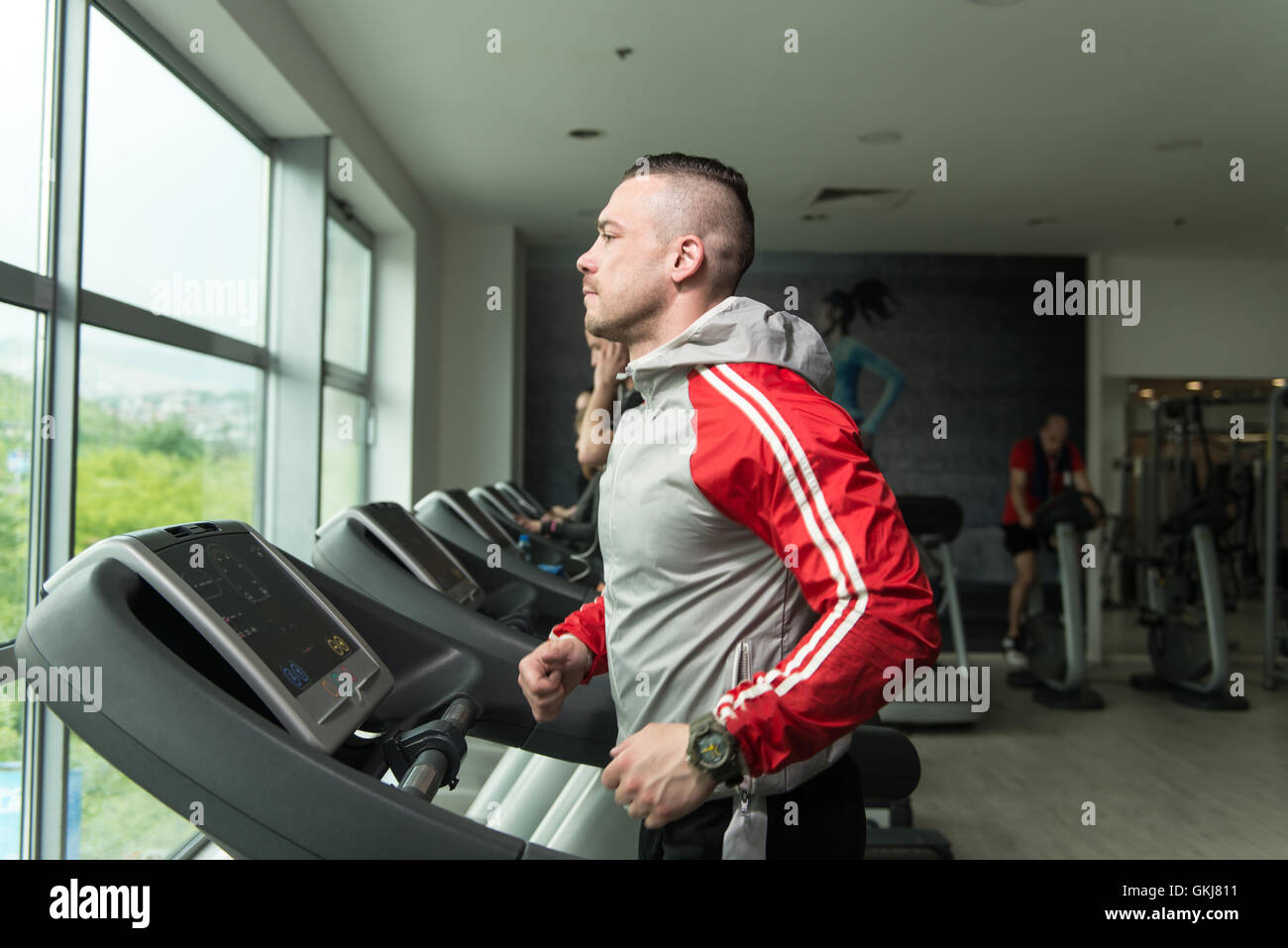 Handsome Man Running On The Treadmill In Gym Stock Photo - Alamy