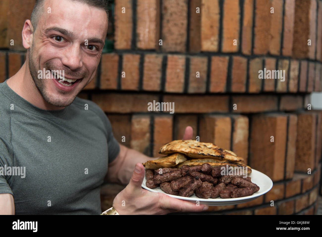 Young Man Is Very Hungry - He Is Ready To Eat Cevapi In Bread Stock ...