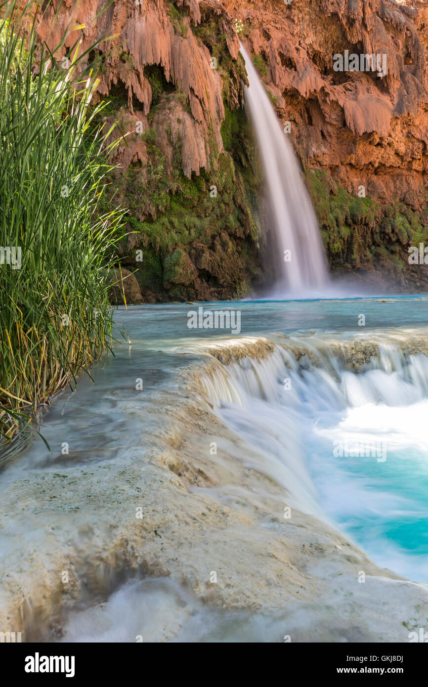 A travertine ledge below Havasu Falls where it plunges into a deep blue ...